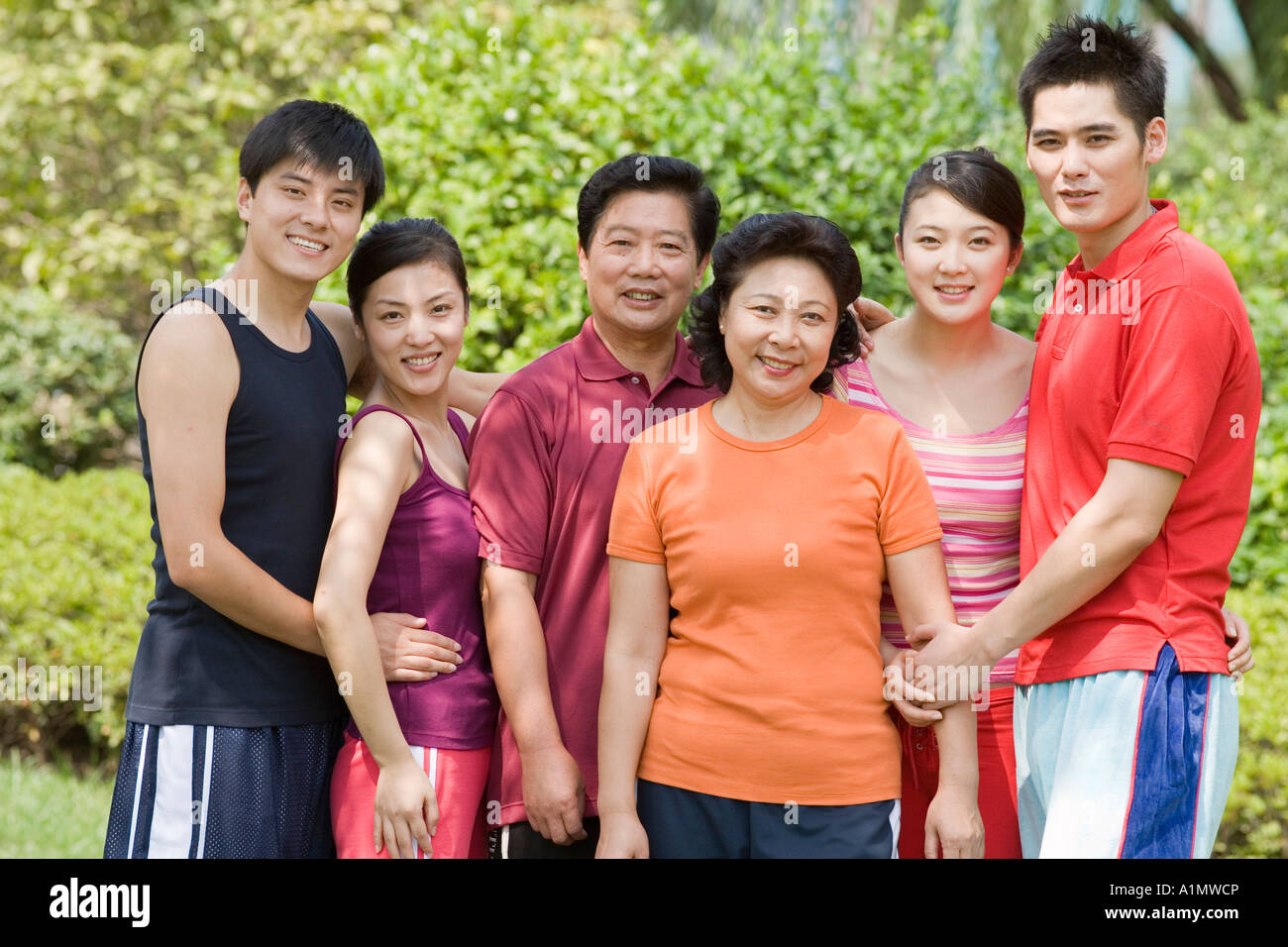 Parents and their adult children smiling together outdoors Stock Photo ...