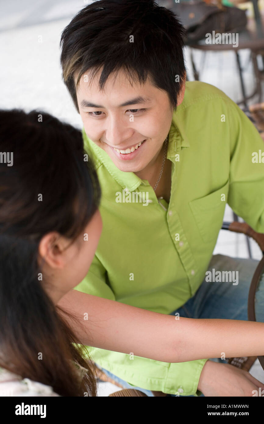 Young couple smiling at each other Stock Photo - Alamy