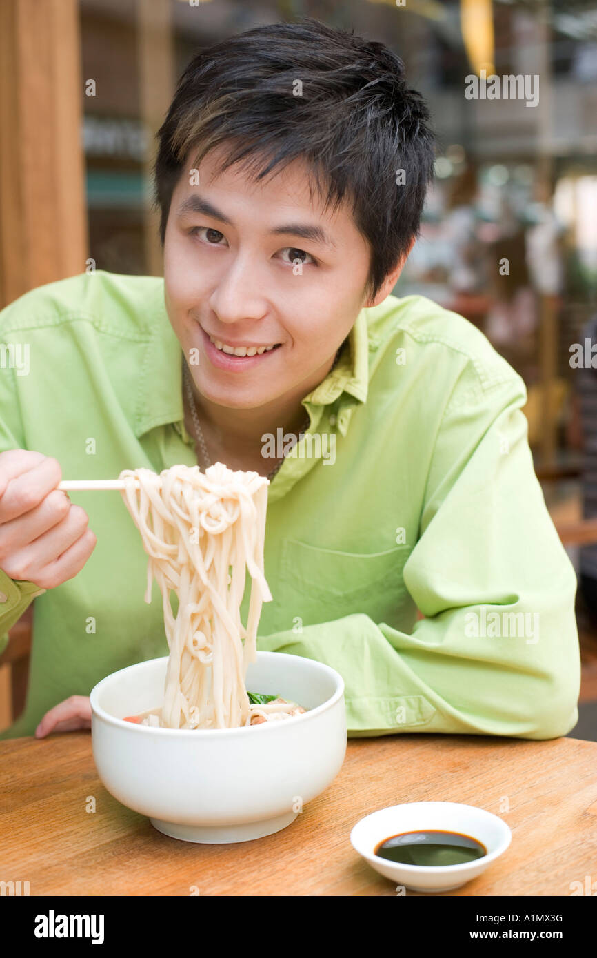 Chinese boy eating noodle soup hi-res stock photography and images - Alamy