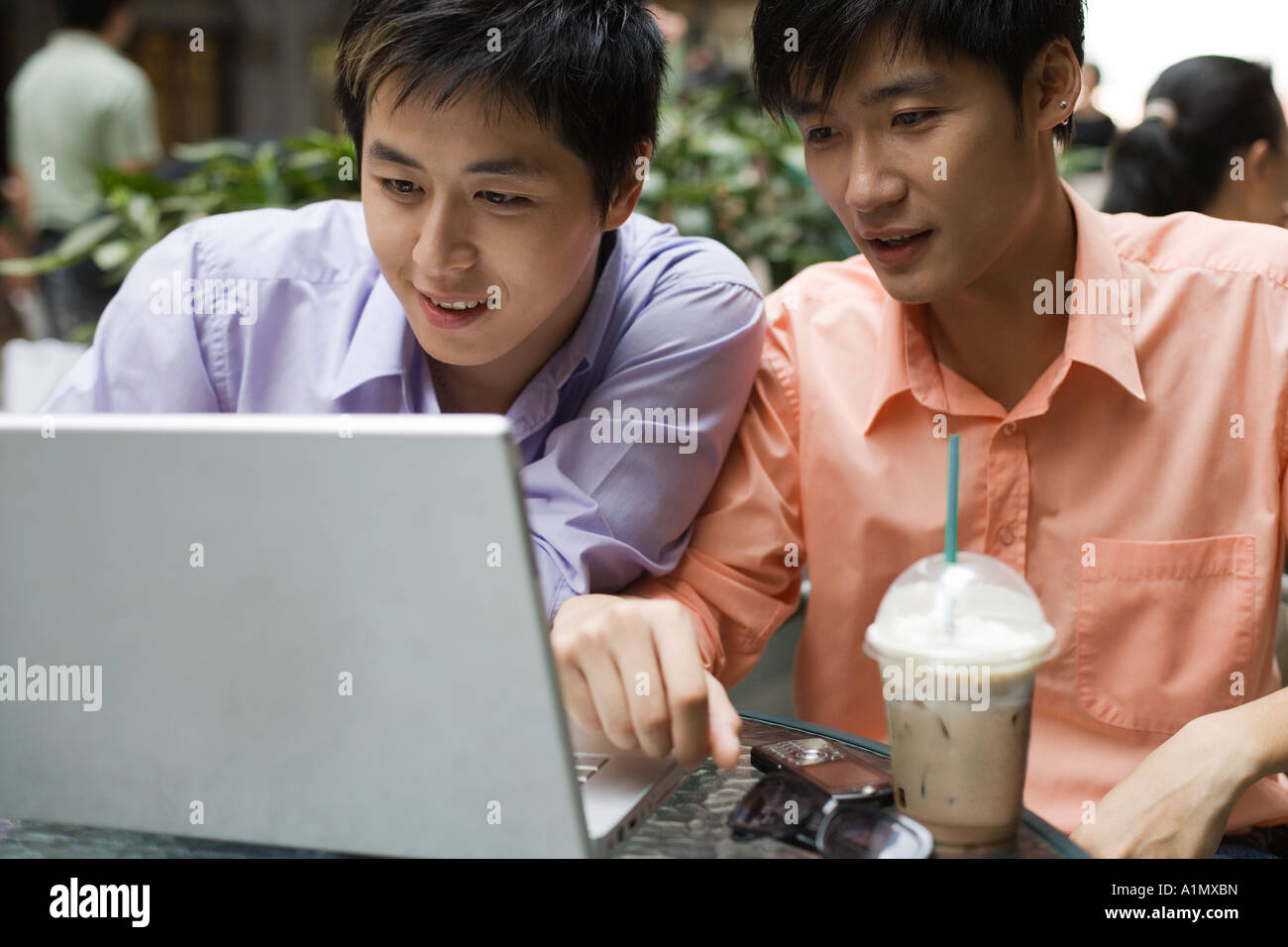 Young men using a laptop Stock Photo - Alamy