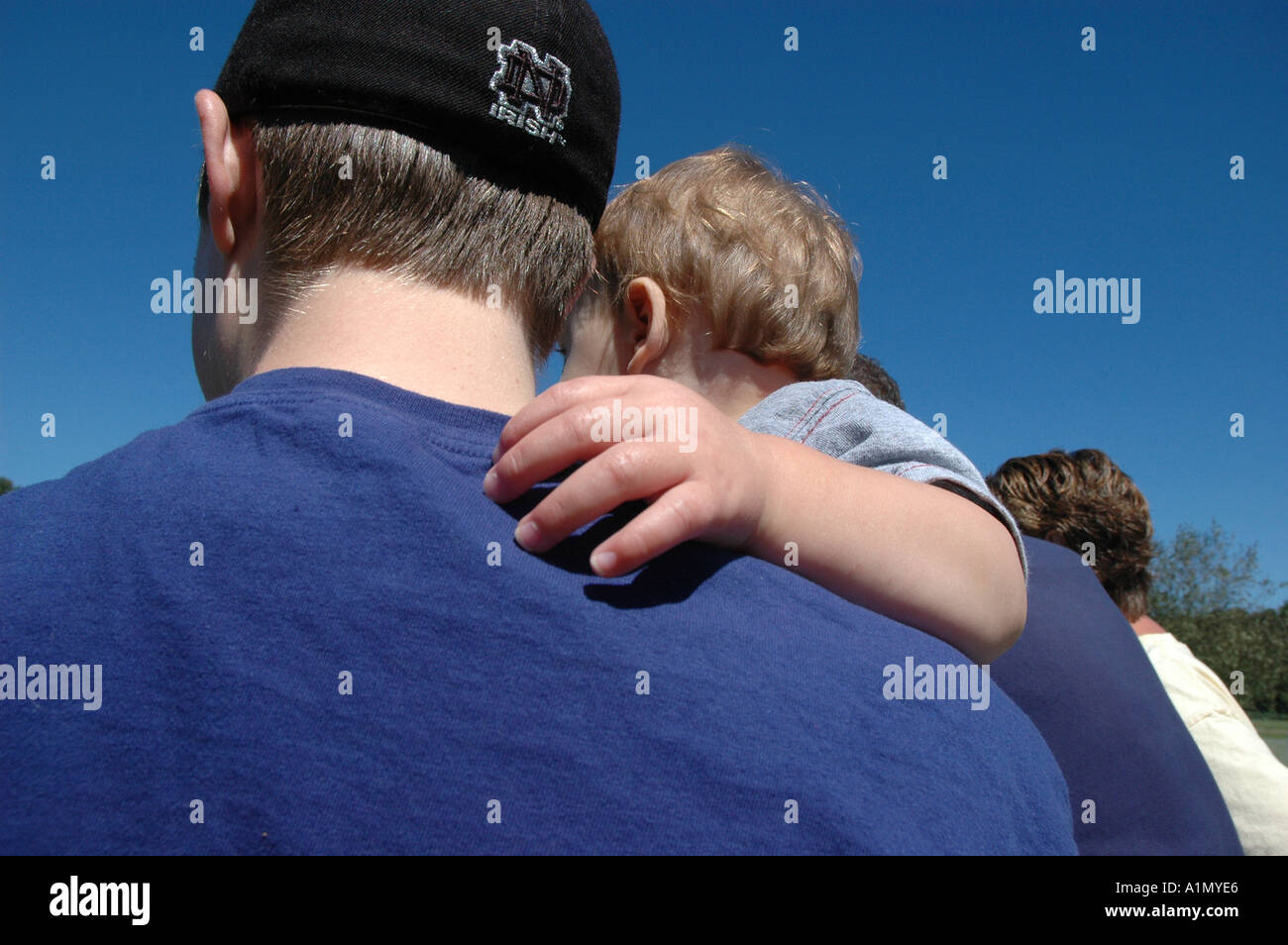 Father and son with arm around dad Stock Photo - Alamy