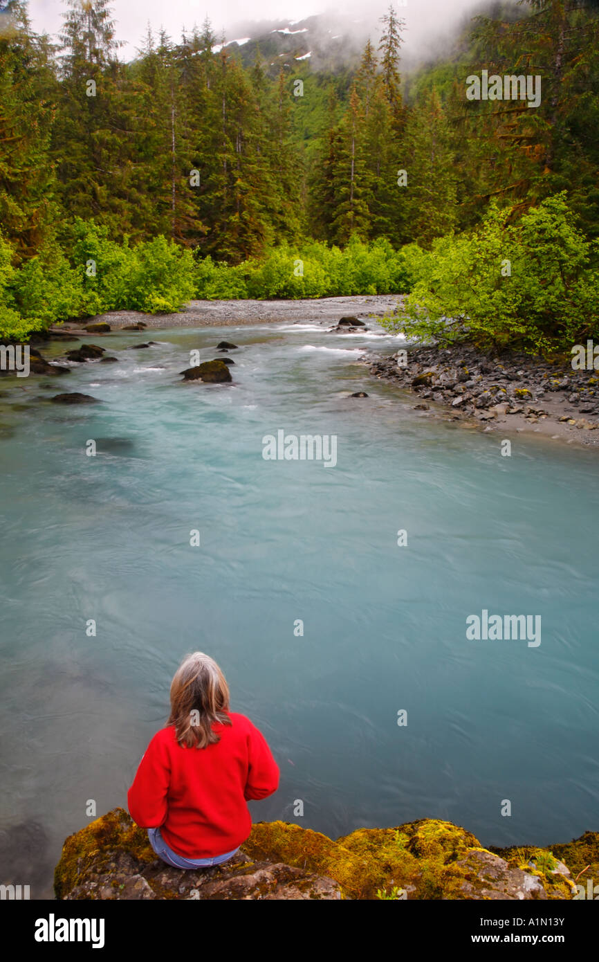 A visitor enjoys Power Creek Cordova Chugach National Forest Alaska MR ...