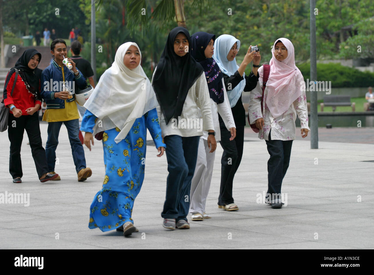 Group of Muslim Malay women walk together while shopping outside the ...