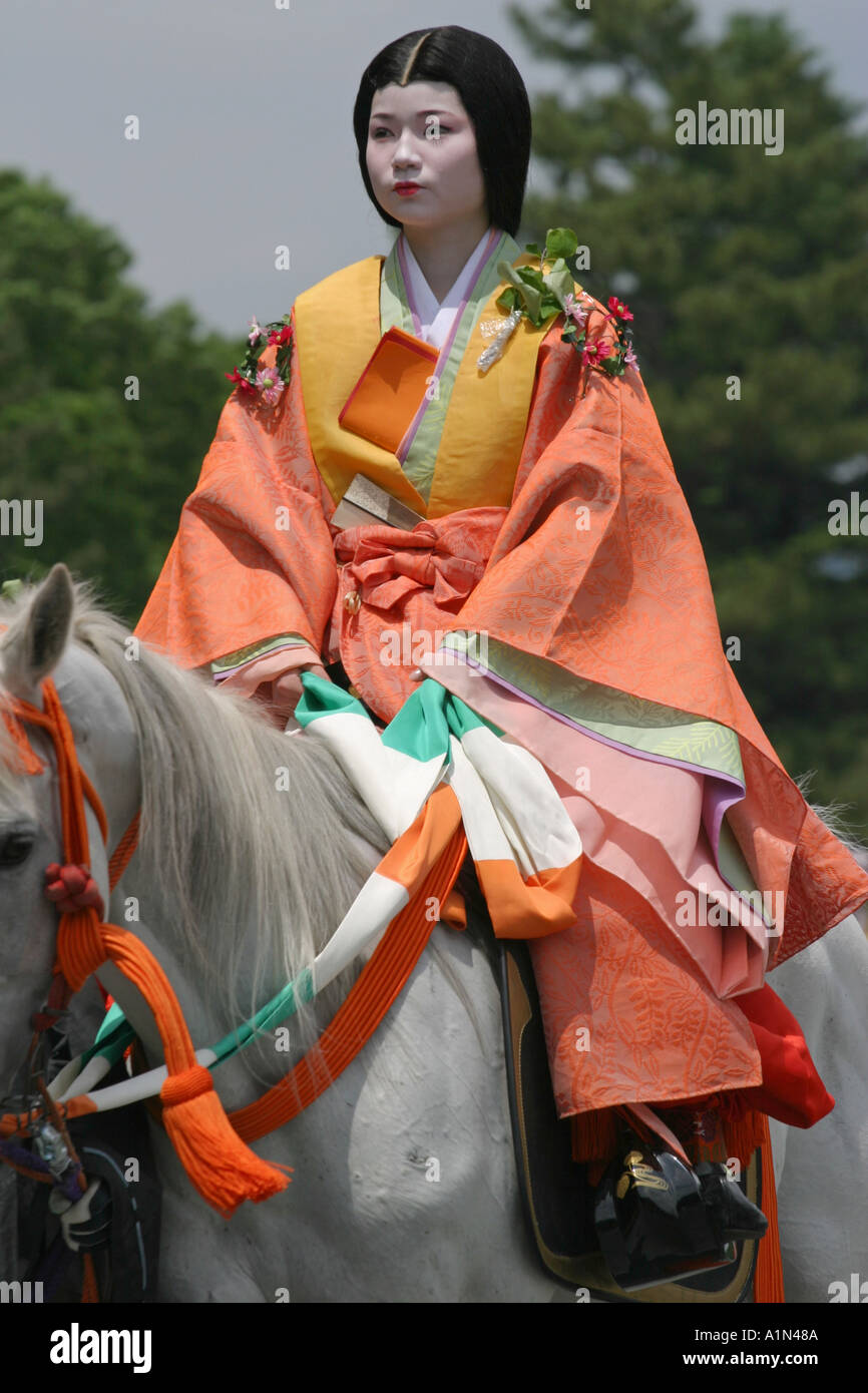 Japanese woman riding horseback wearing a colourful costume and white ...