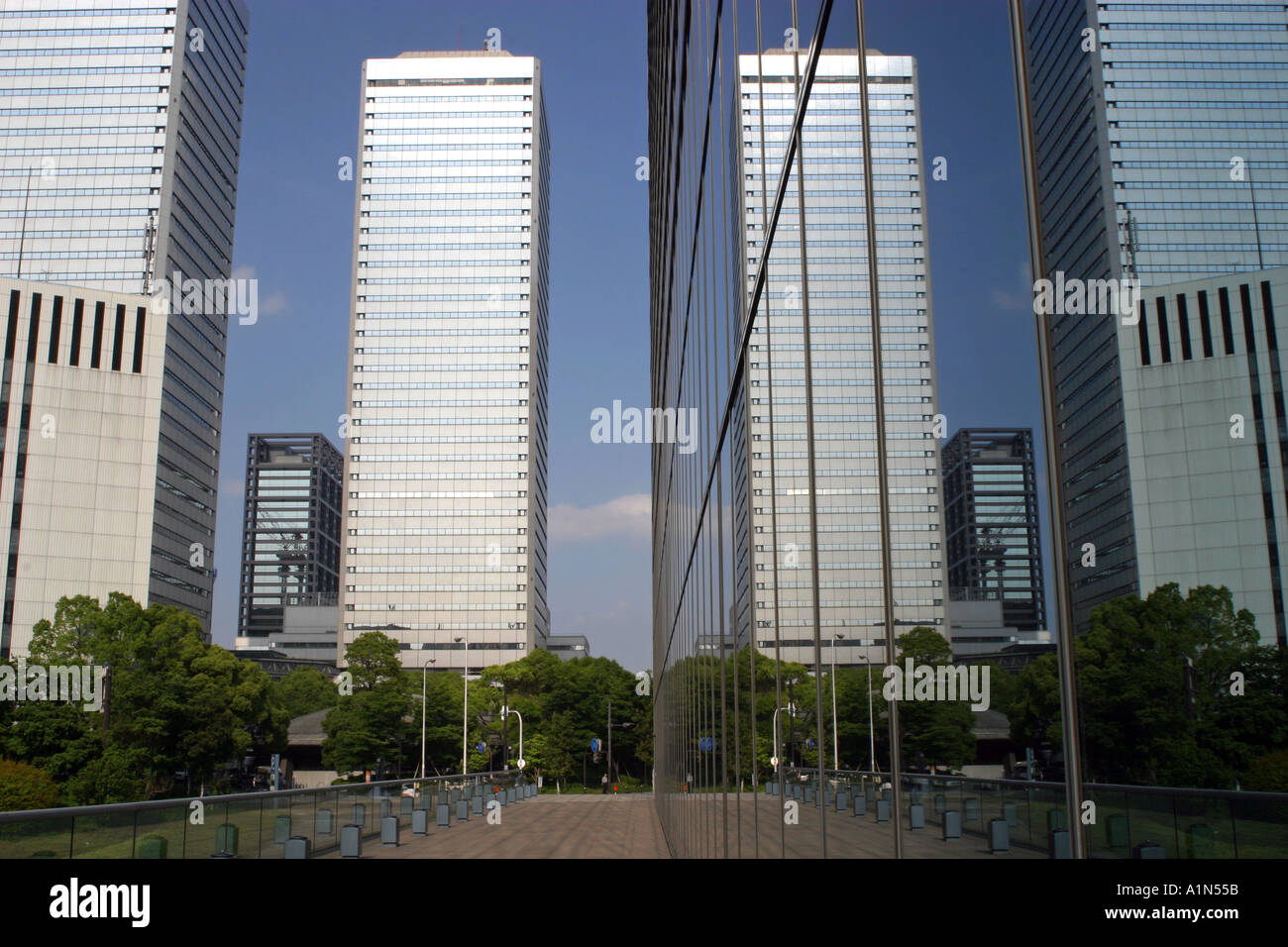 Modern high rise skyscraper buildings reflected in a glass sided modern ...