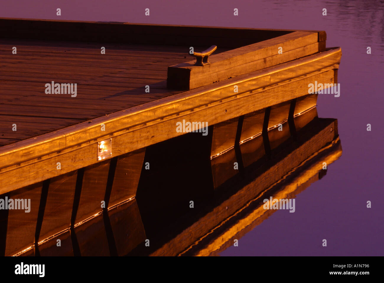 Empty boat dock at sunrise Stock Photo - Alamy