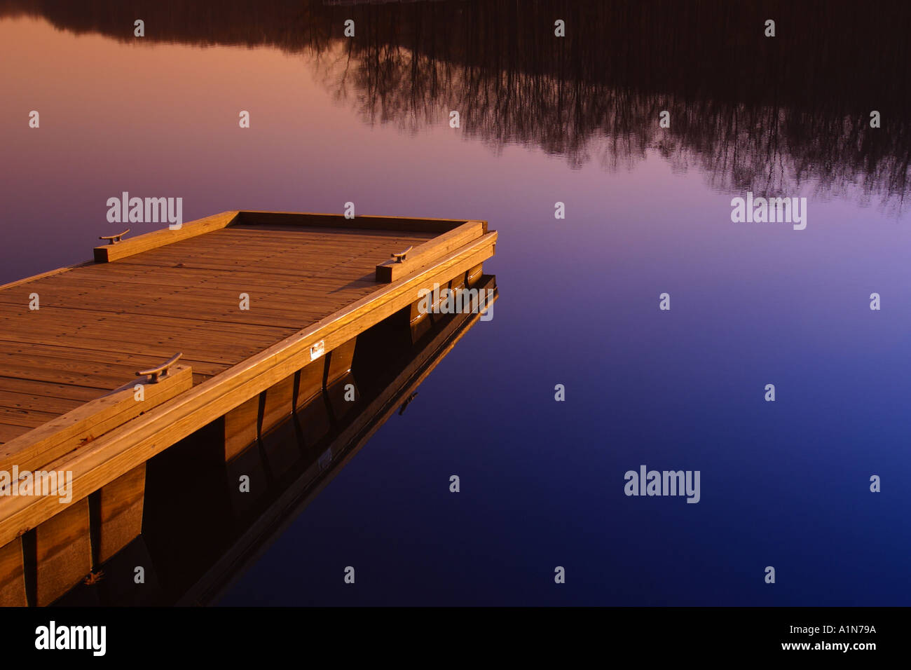 Empty boat dock at sunrise Stock Photo - Alamy