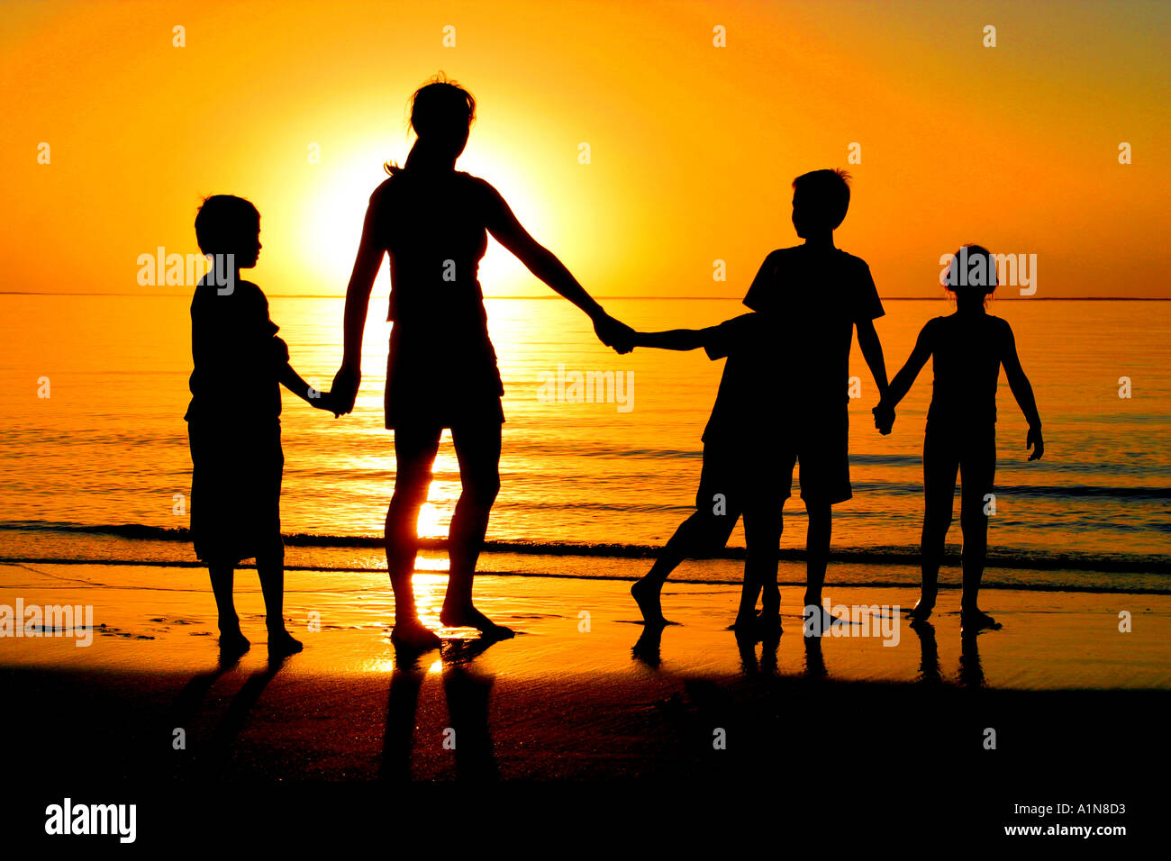 Family at sunset Stock Photo - Alamy