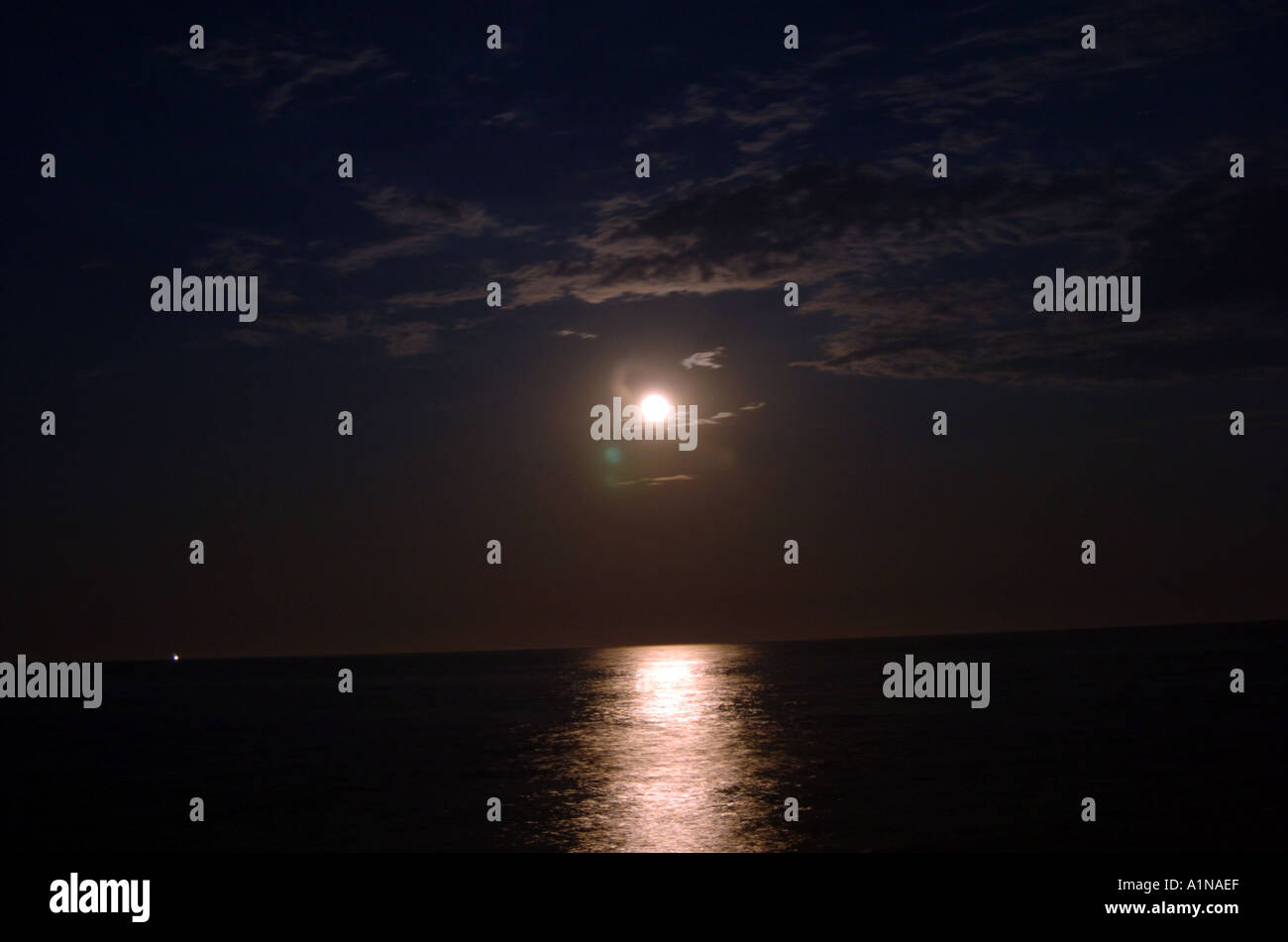 Moon over ocean Stock Photo - Alamy