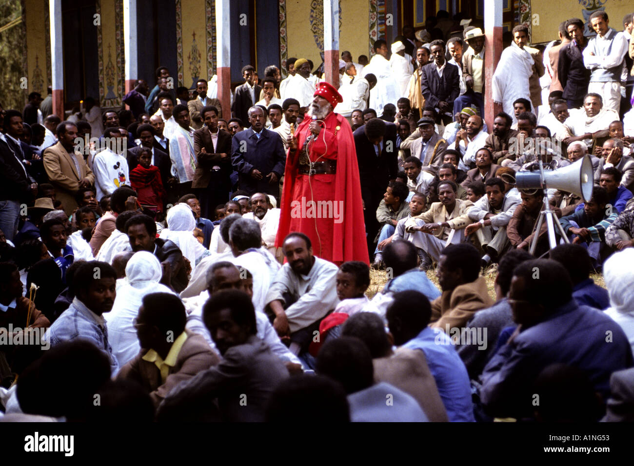 Red clad Ethiopian preacher at feast day ceremonies at Addis Alem ...