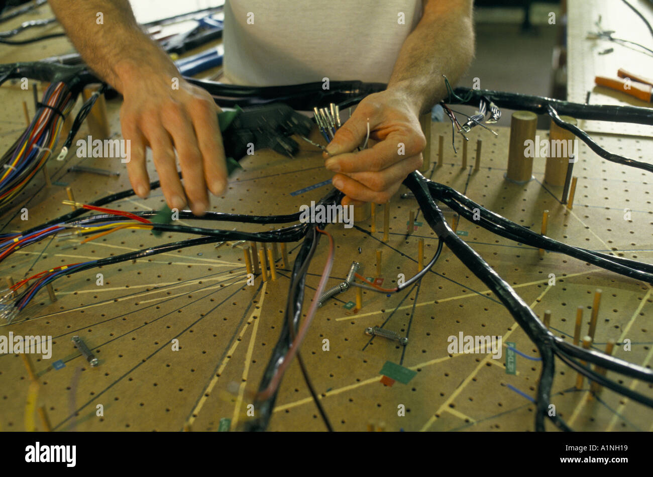 HANDS WIRING CABLE MANUALLY AT ASTON MARTIN FACTORY NEWPORT PAGNELL ...