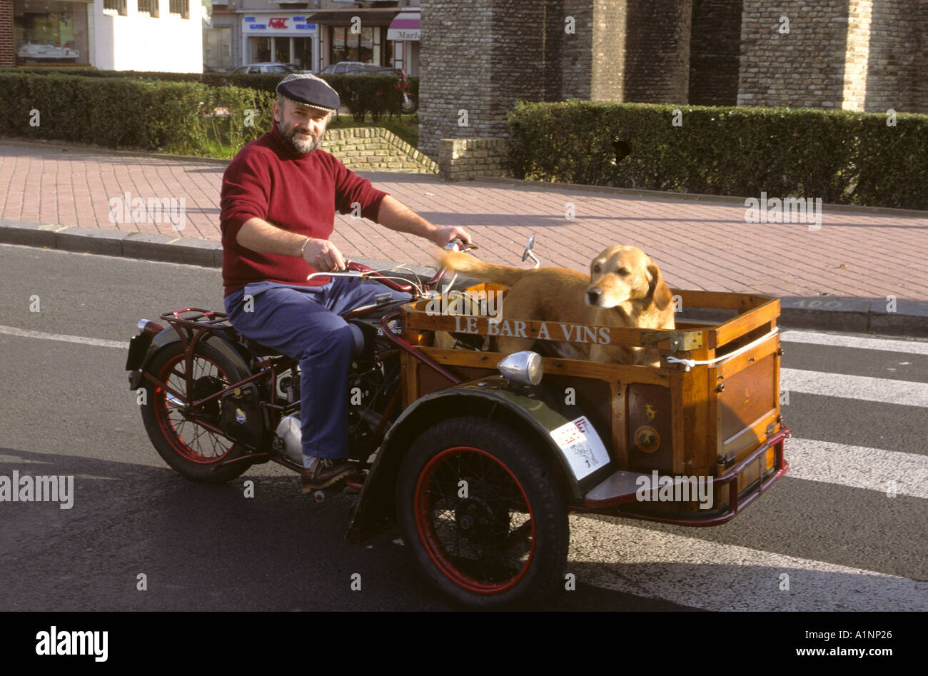 A man and his dog rides his motor triclycle with side car carry at ...