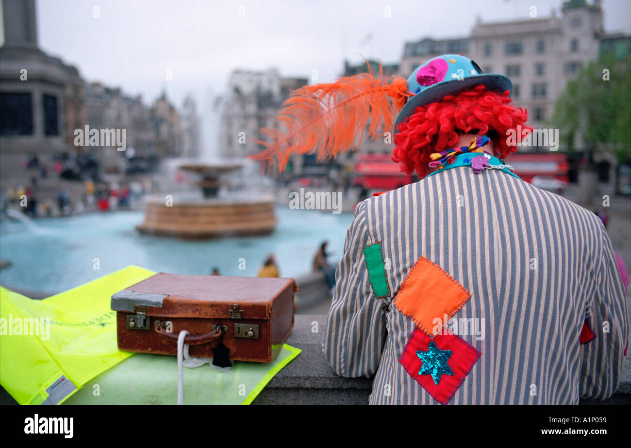 Clown relaxing in Trafalgar Square London Stock Photo - Alamy