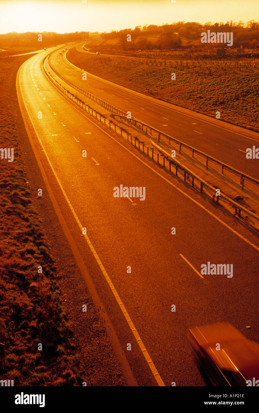Empty road at sunset Stock Photo - Alamy