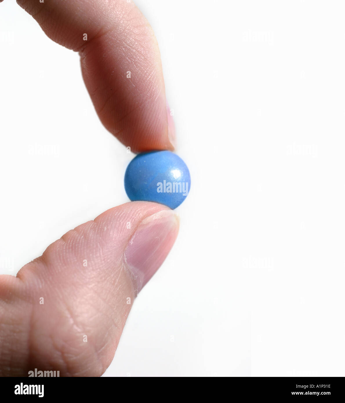 finger holding blue pill Stock Photo - Alamy