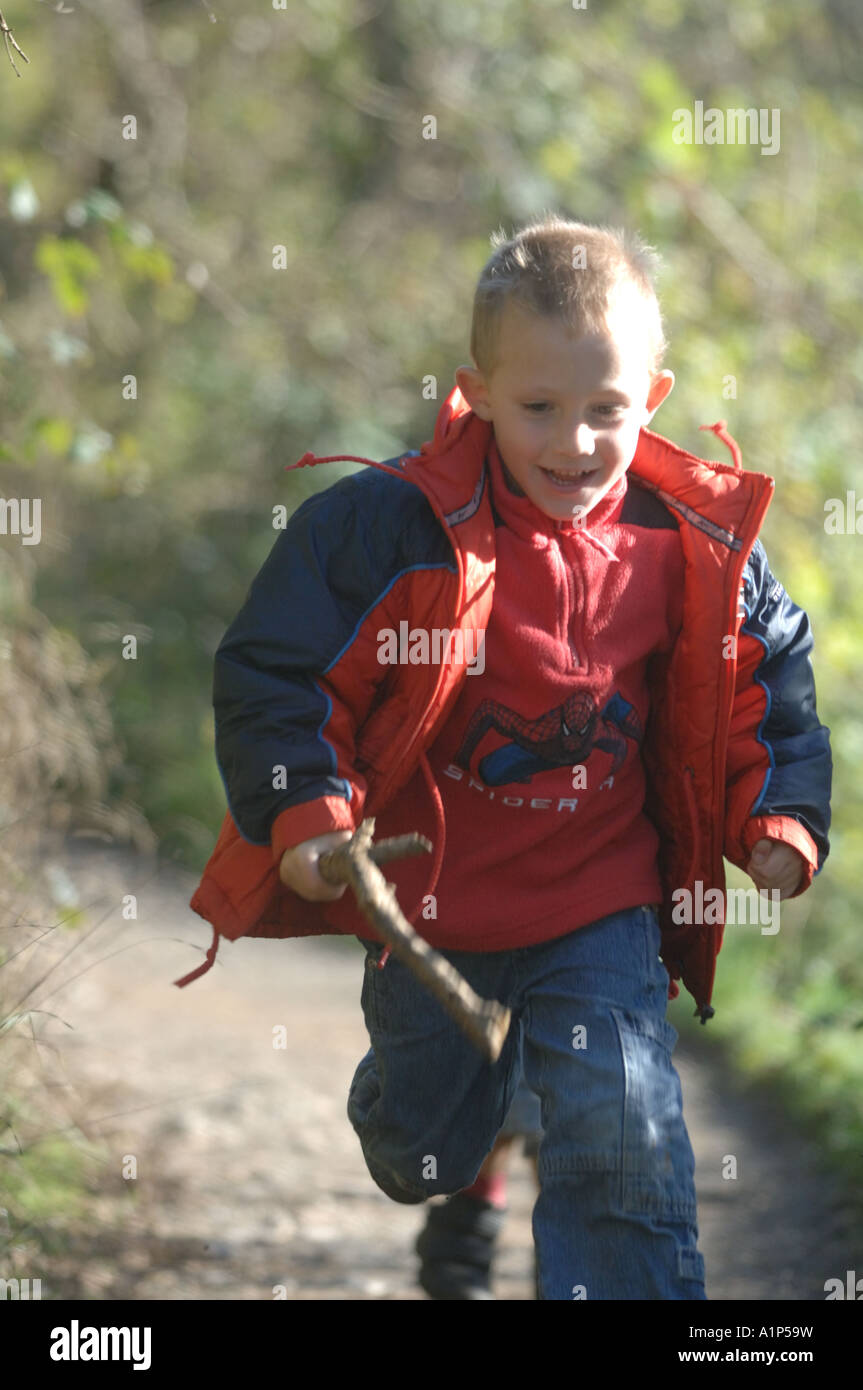 Portrait of young boy running with stick Bosherston Lily Ponds ...