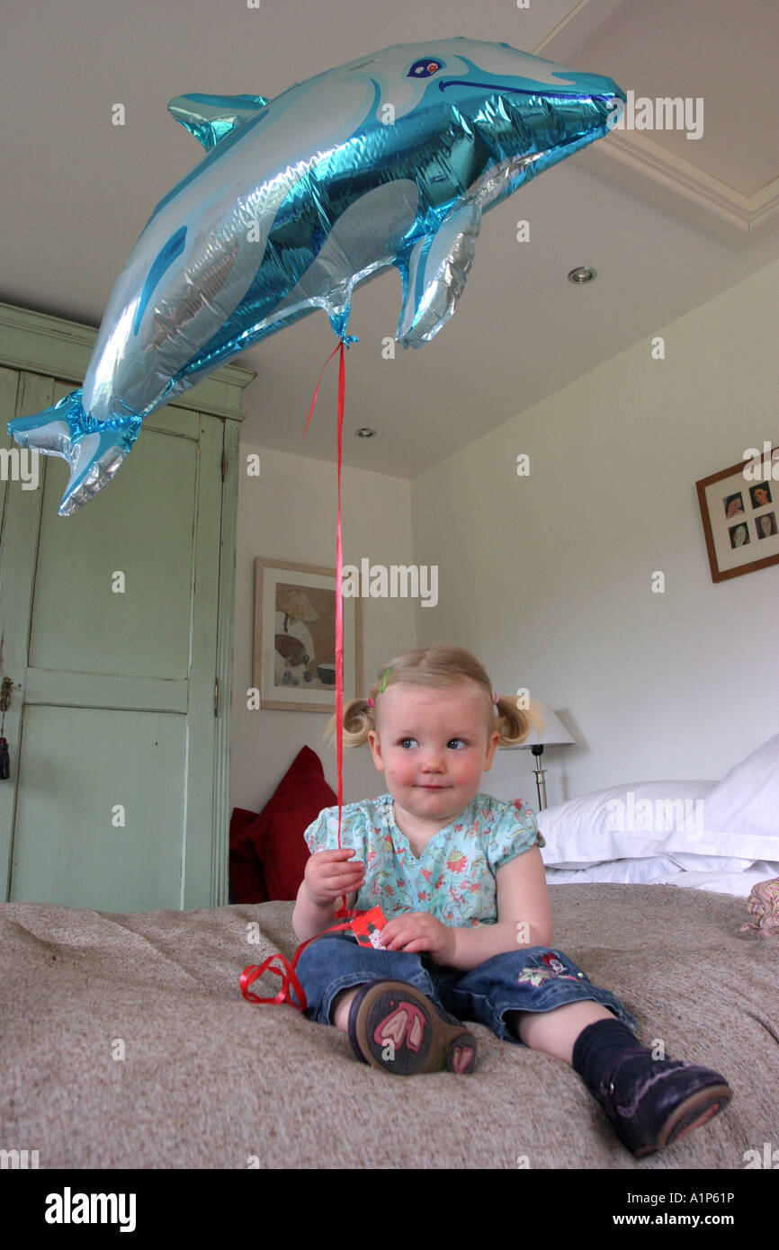 Girl holding helium balloon Stock Photo - Alamy