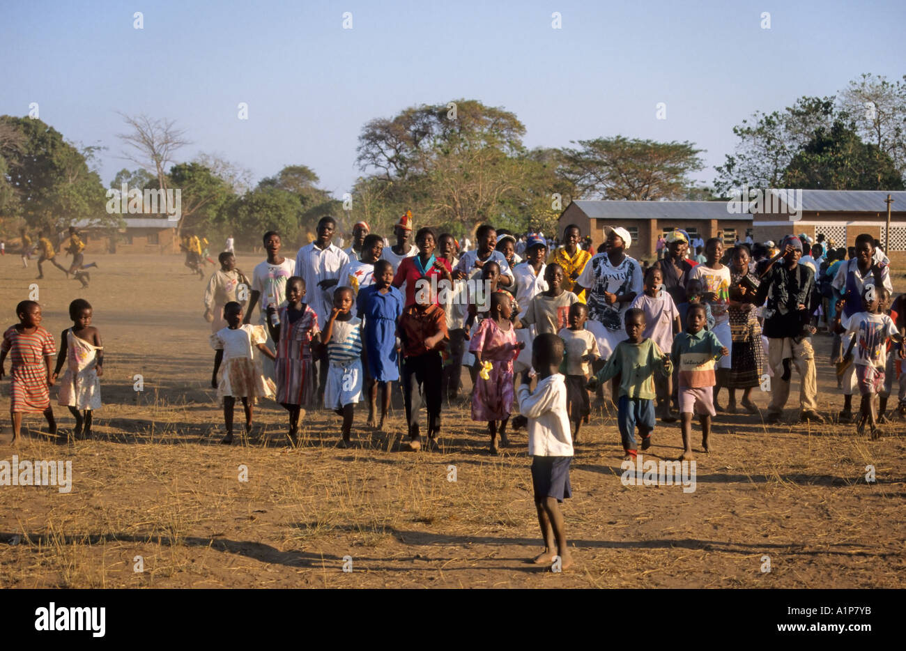 Crowd chanting and dancing around a football pitch while the game goes ...