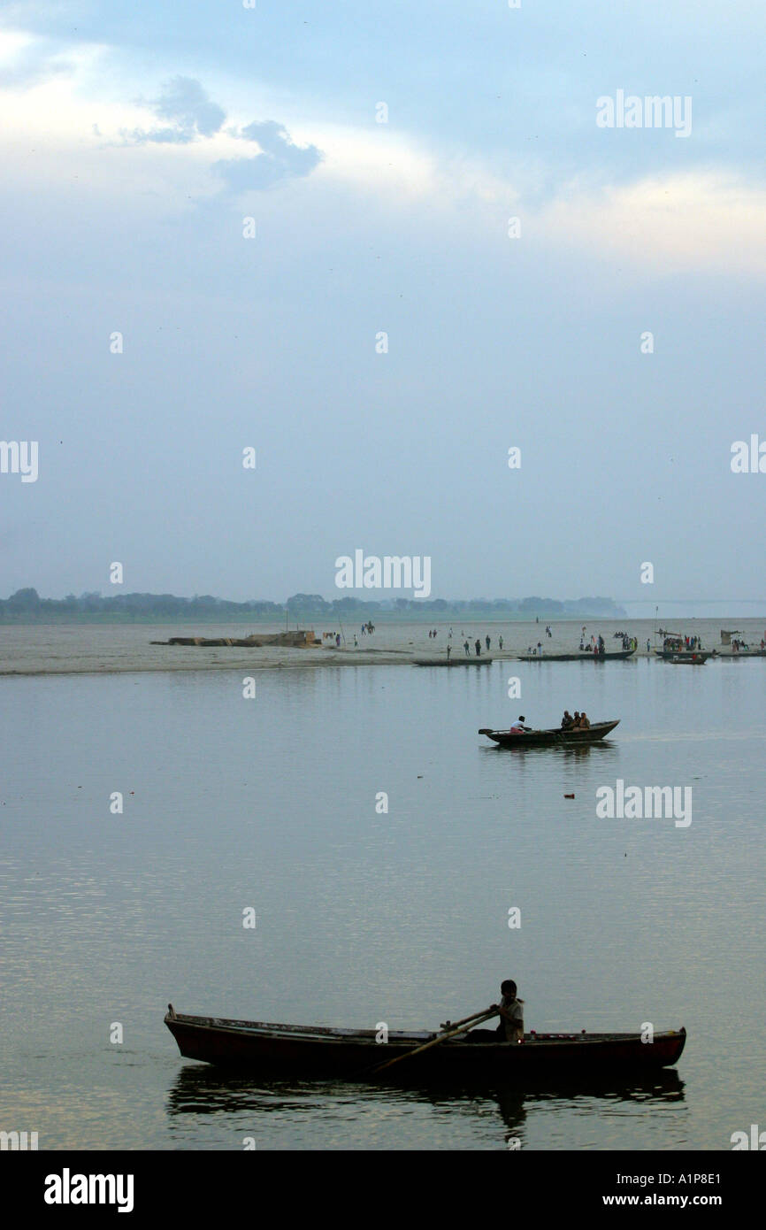 Boats travel on the holy river Ganges in Varanasi in northern India ...