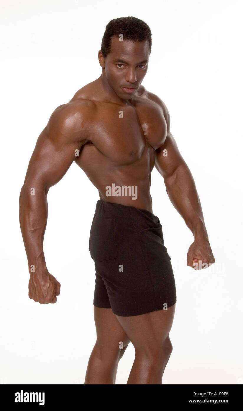 Side view of African American male bodybuilder showing muscular ...