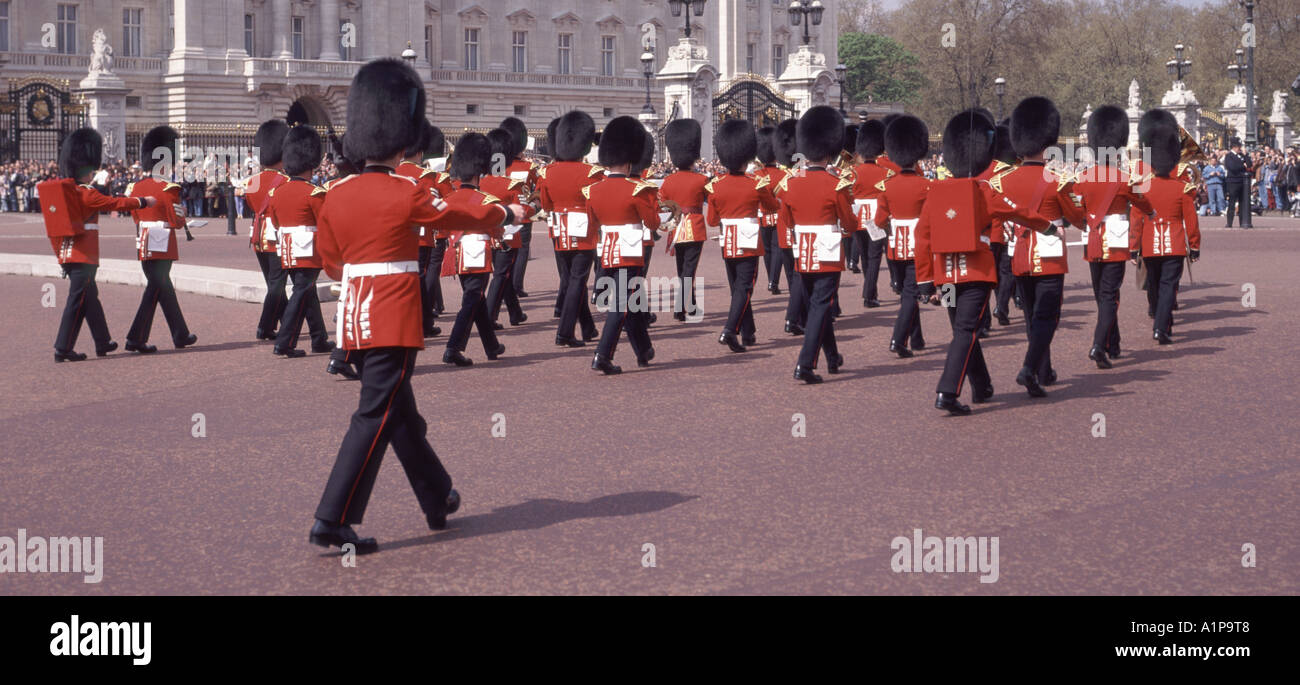 Tourists at changing guard ceremony back view men of British guards ...