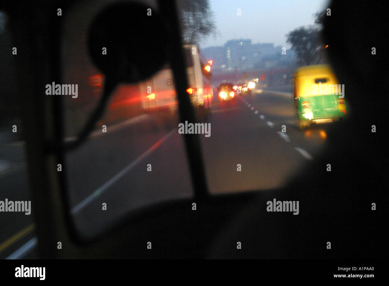 A view from inside an auto-rickshaw driving on a road in New Delhi in ...