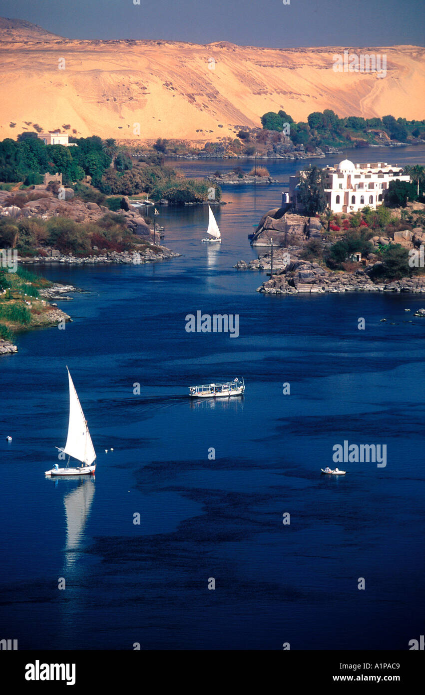 Two lateen sail feluccas and other river boats on the River Nile Aswan ...