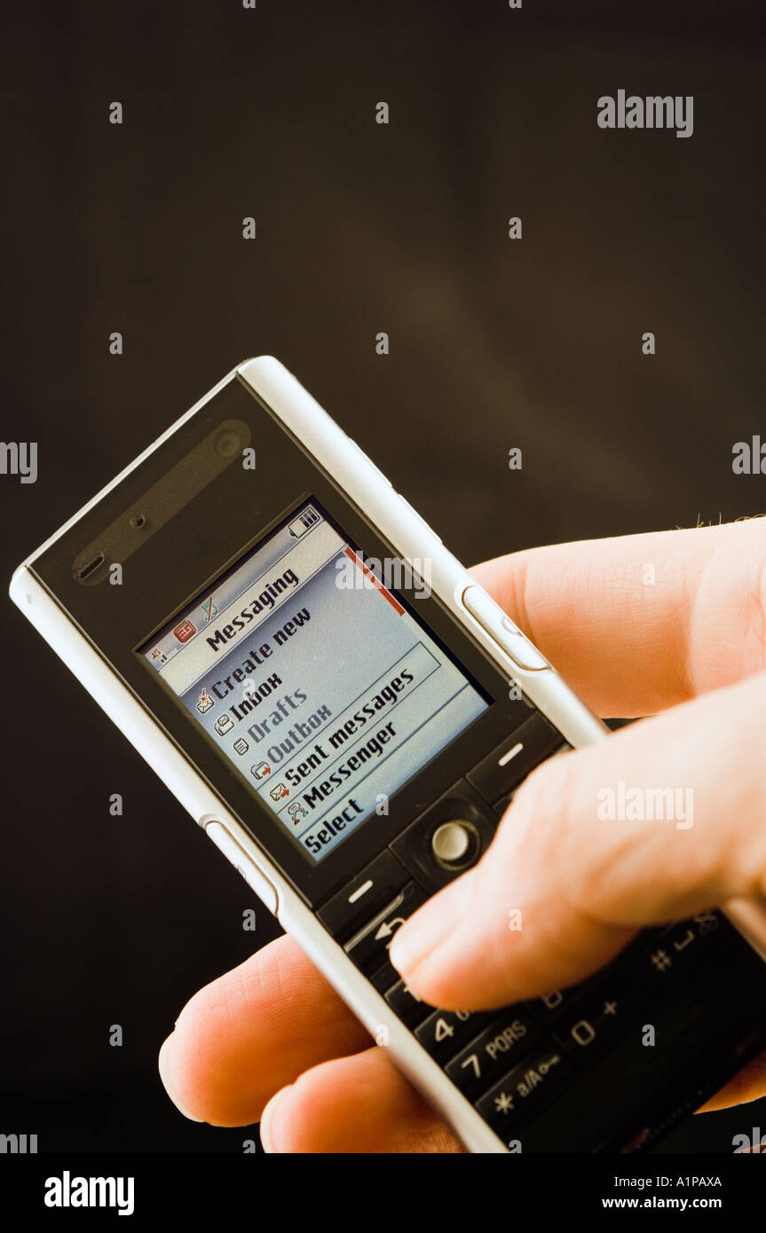 hand with mobile telephone about to send a text message Stock Photo - Alamy