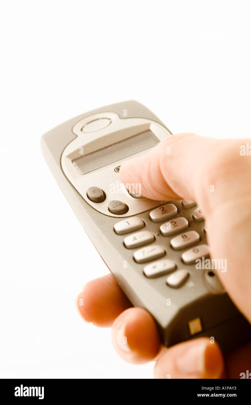 hand holding a telephone dialing a number on a walk about phone Stock ...