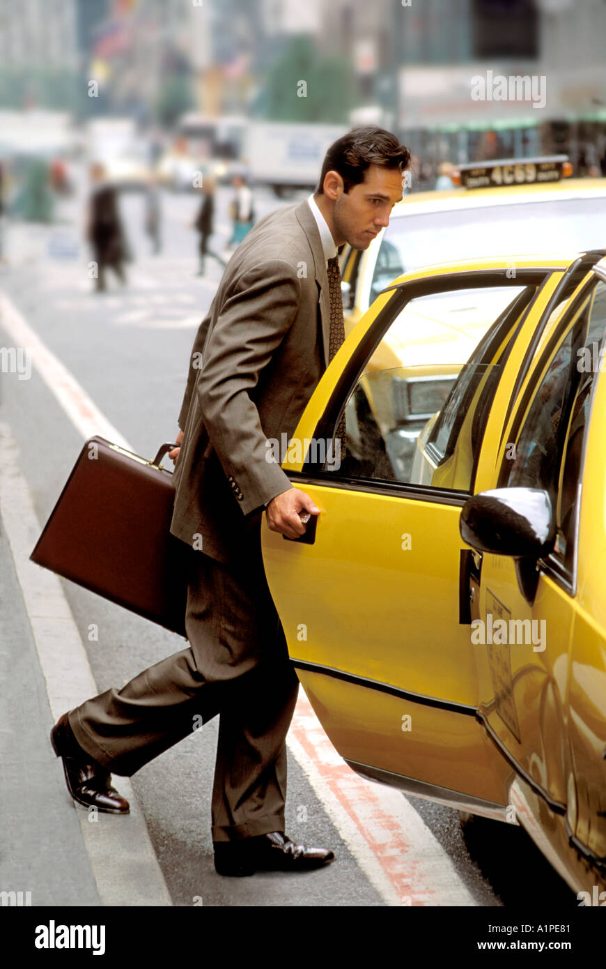 Businessman catching taxi Stock Photo - Alamy