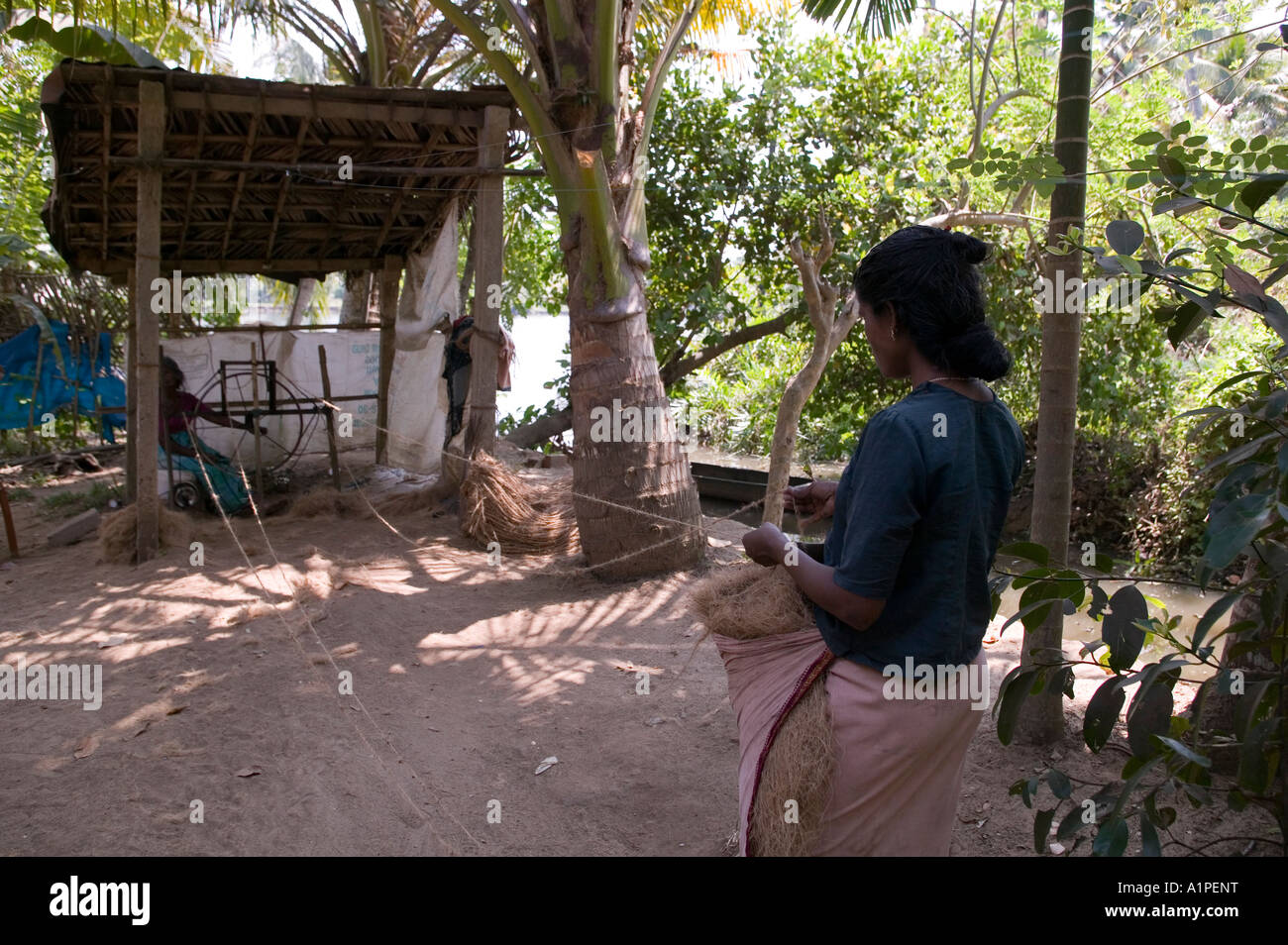 Two women spin jute to make rope in Kerala India Stock Photo - Alamy