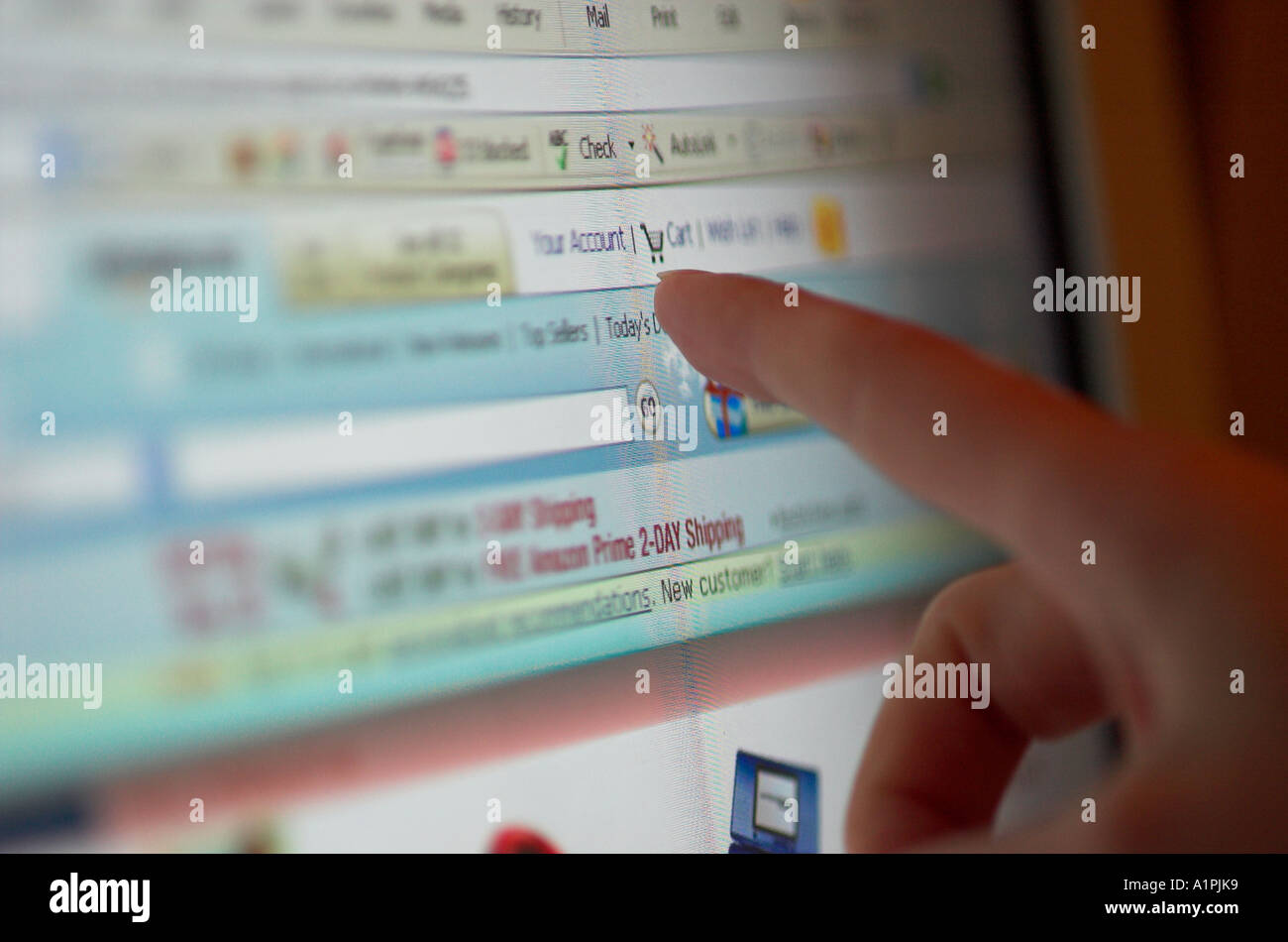 Finger pointing at cart on computer screen Stock Photo - Alamy