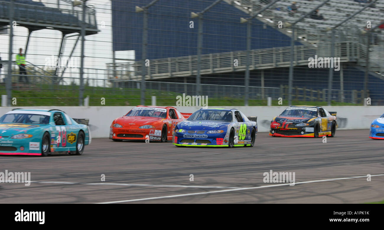 V8 Nascar type stock cars racing on a banked oval circuit Stock Photo ...