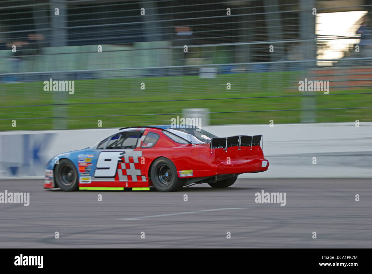 V8 Nascar type stock cars racing on a banked oval circuit Stock Photo ...