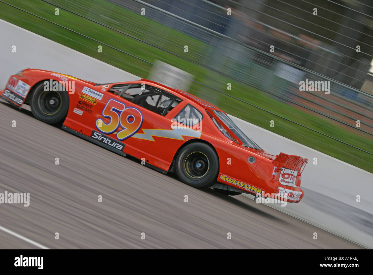 V8 Nascar type stock cars racing on a banked oval circuit Stock Photo ...