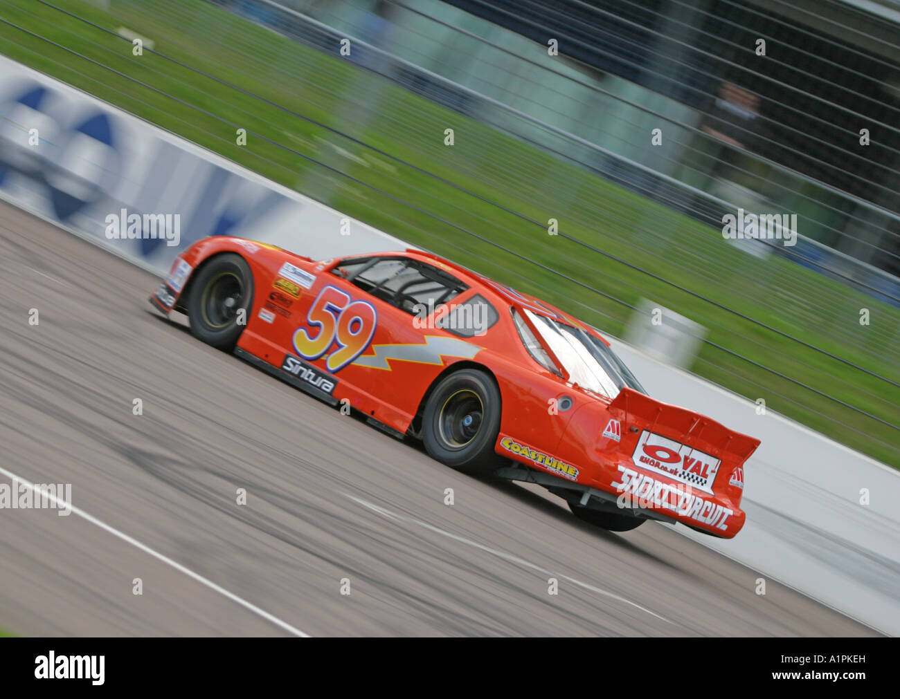 V8 Nascar type stock cars racing on a banked oval circuit Stock Photo ...