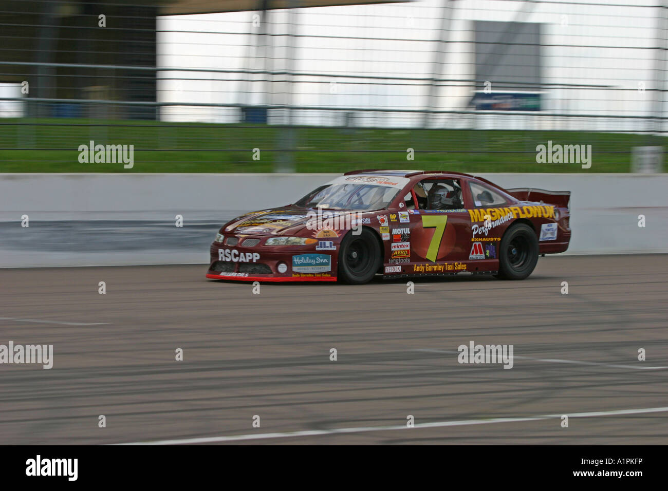 V8 Nascar type stock cars racing on a banked oval circuit Stock Photo ...