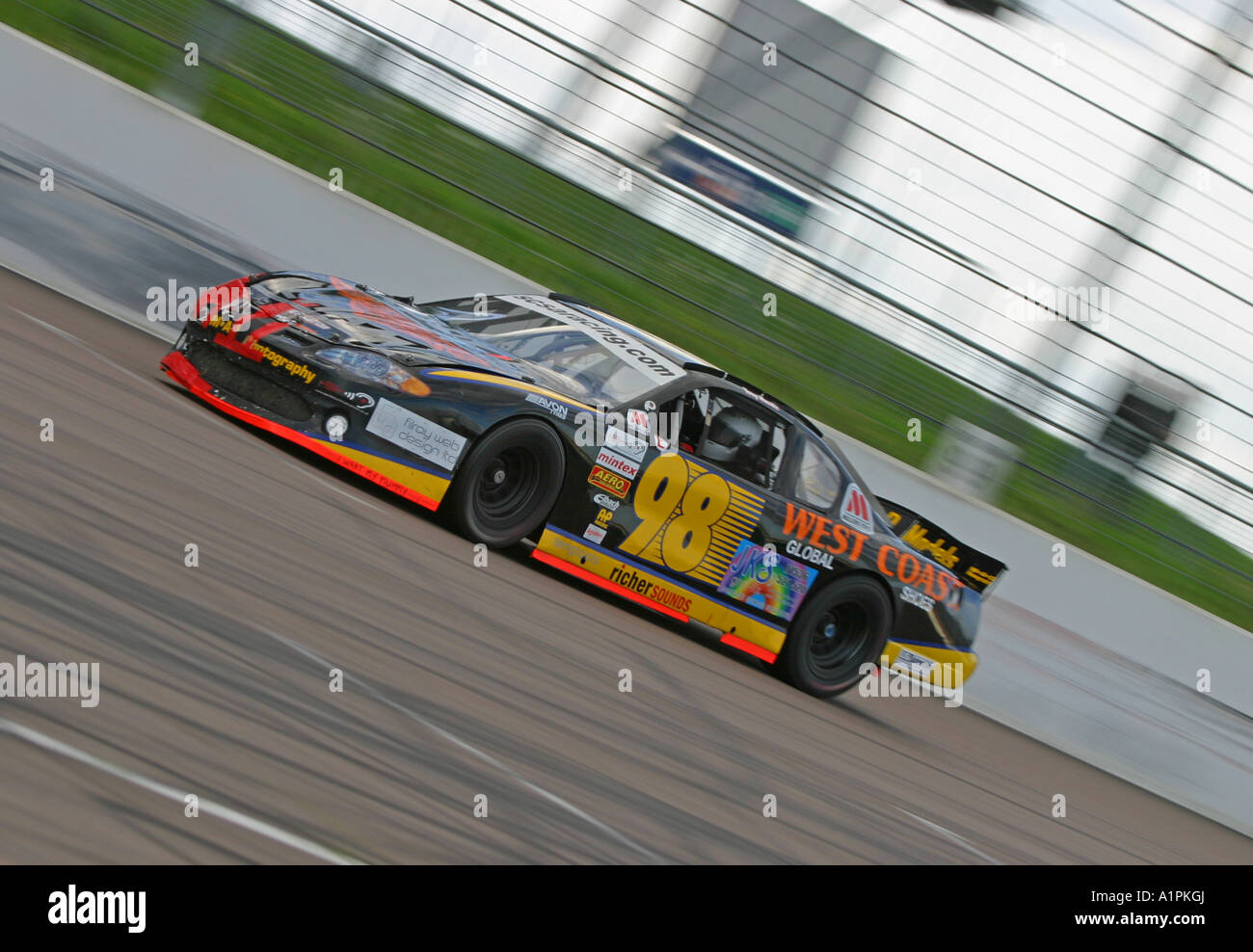 V8 Nascar type stock cars racing on a banked oval circuit Stock Photo ...