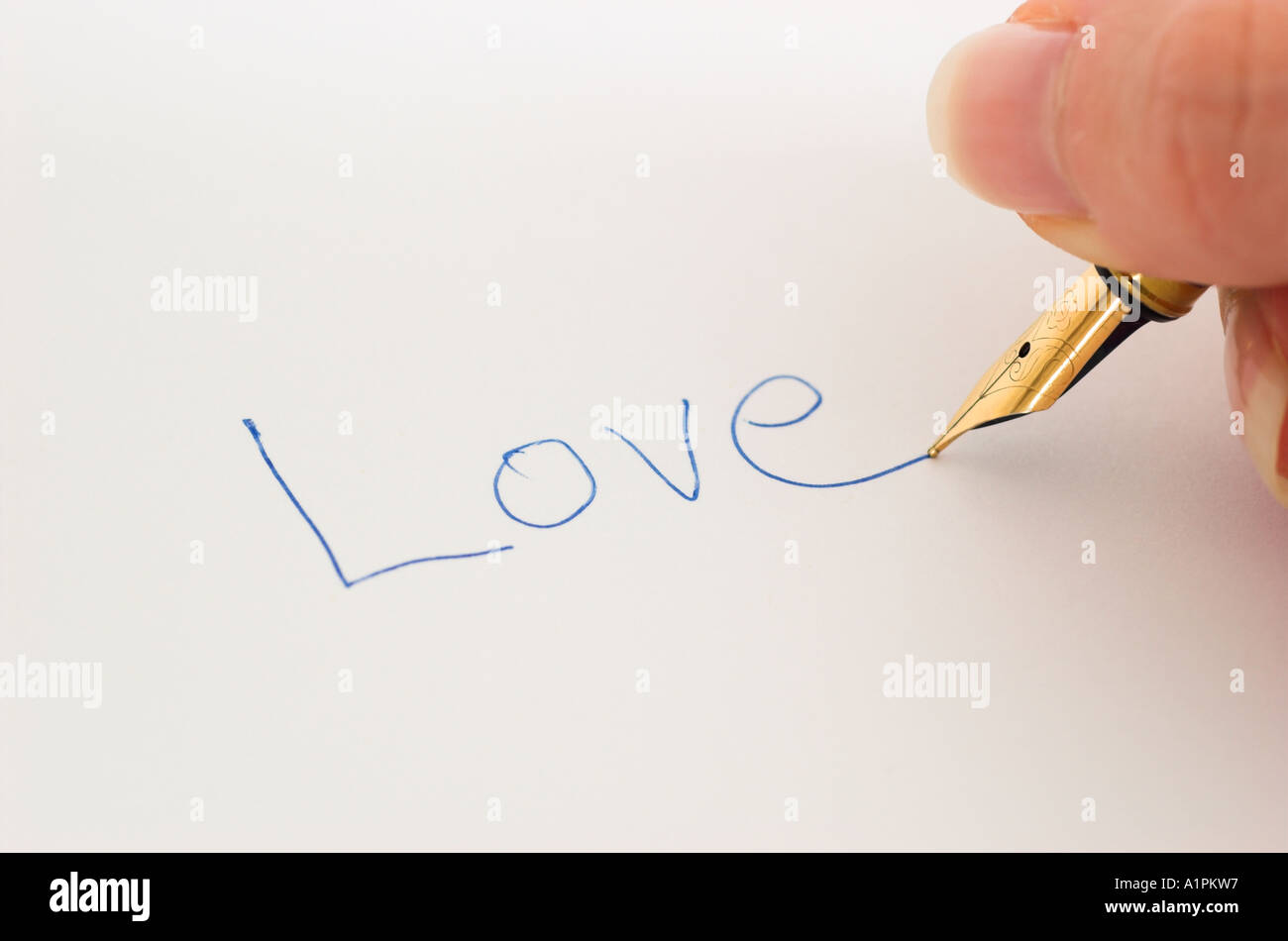 Hand writing word Love on paper with fountain pen Stock Photo - Alamy