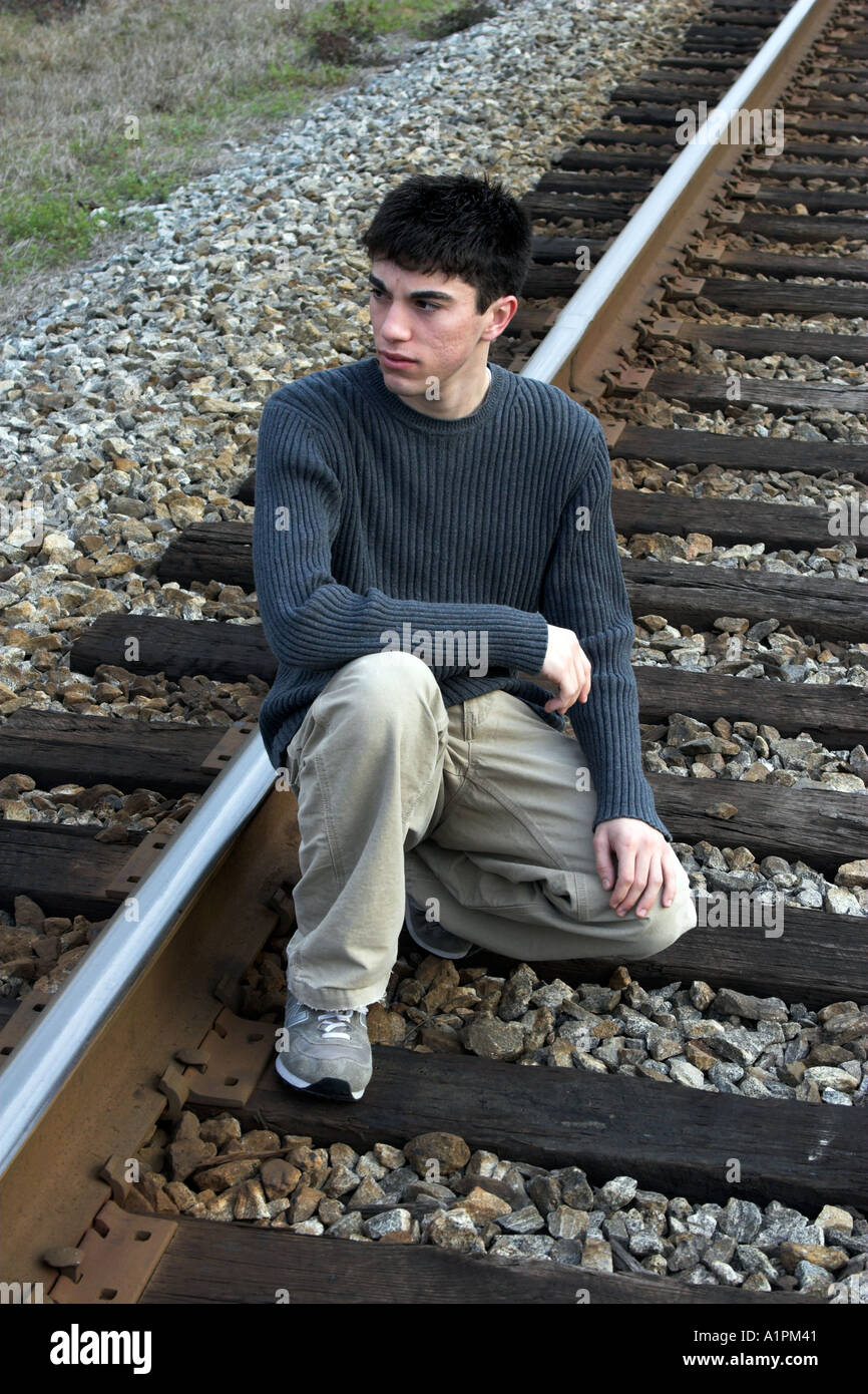Young man on railroad tracks hi-res stock photography and images - Alamy