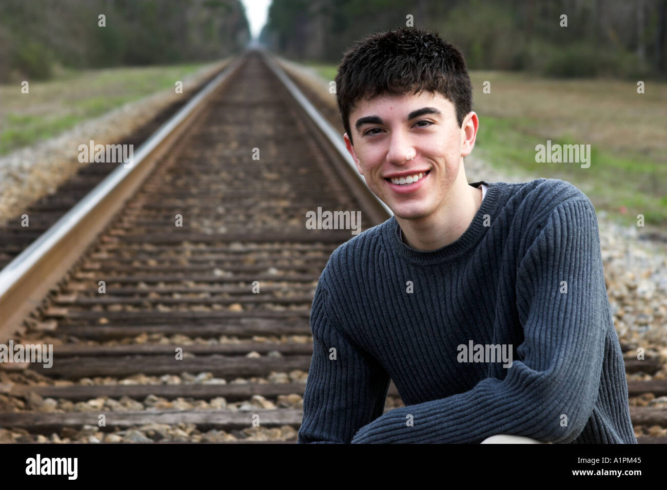 Young man on railroad tracks hi-res stock photography and images - Alamy