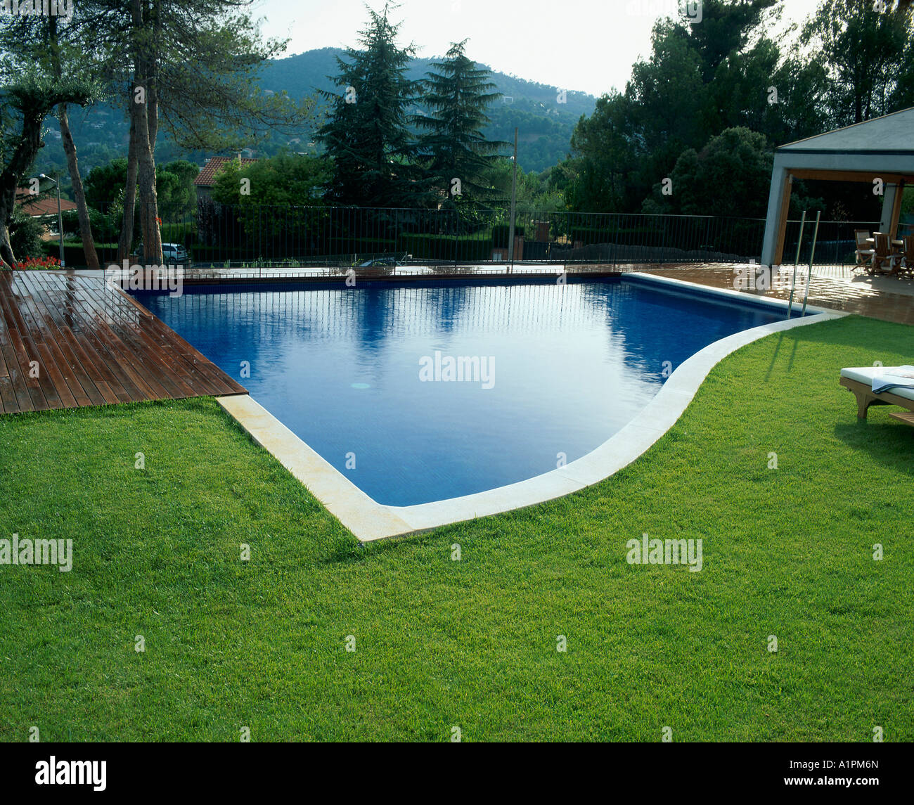 View of a swimming pool with trees at the back Stock Photo - Alamy