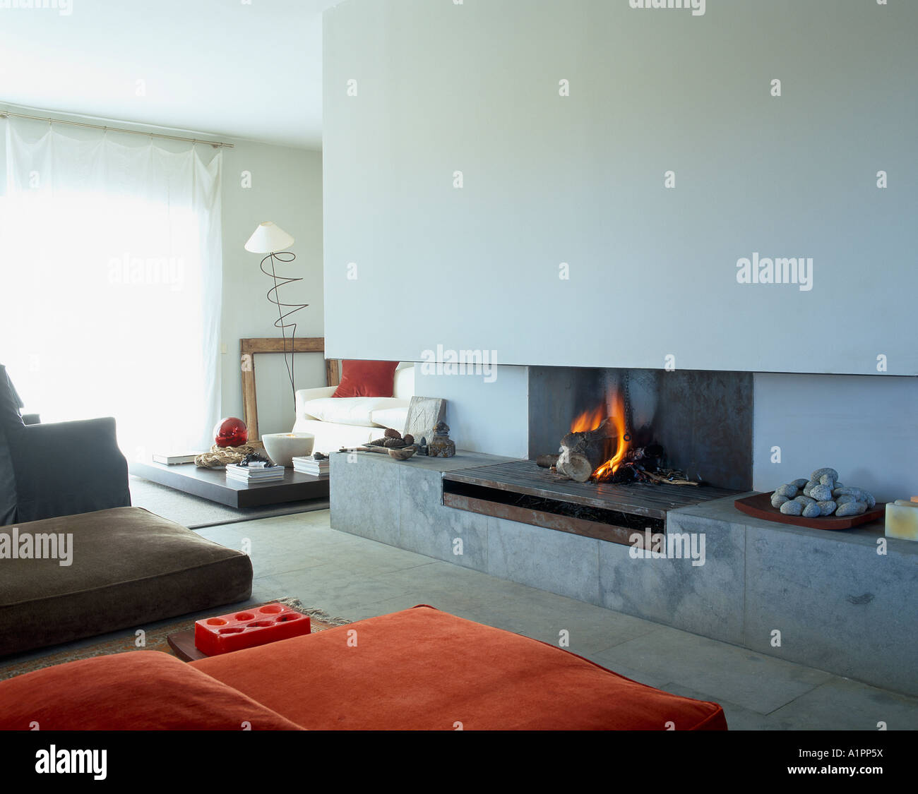 View of a lighted fireplace in a living room Stock Photo - Alamy
