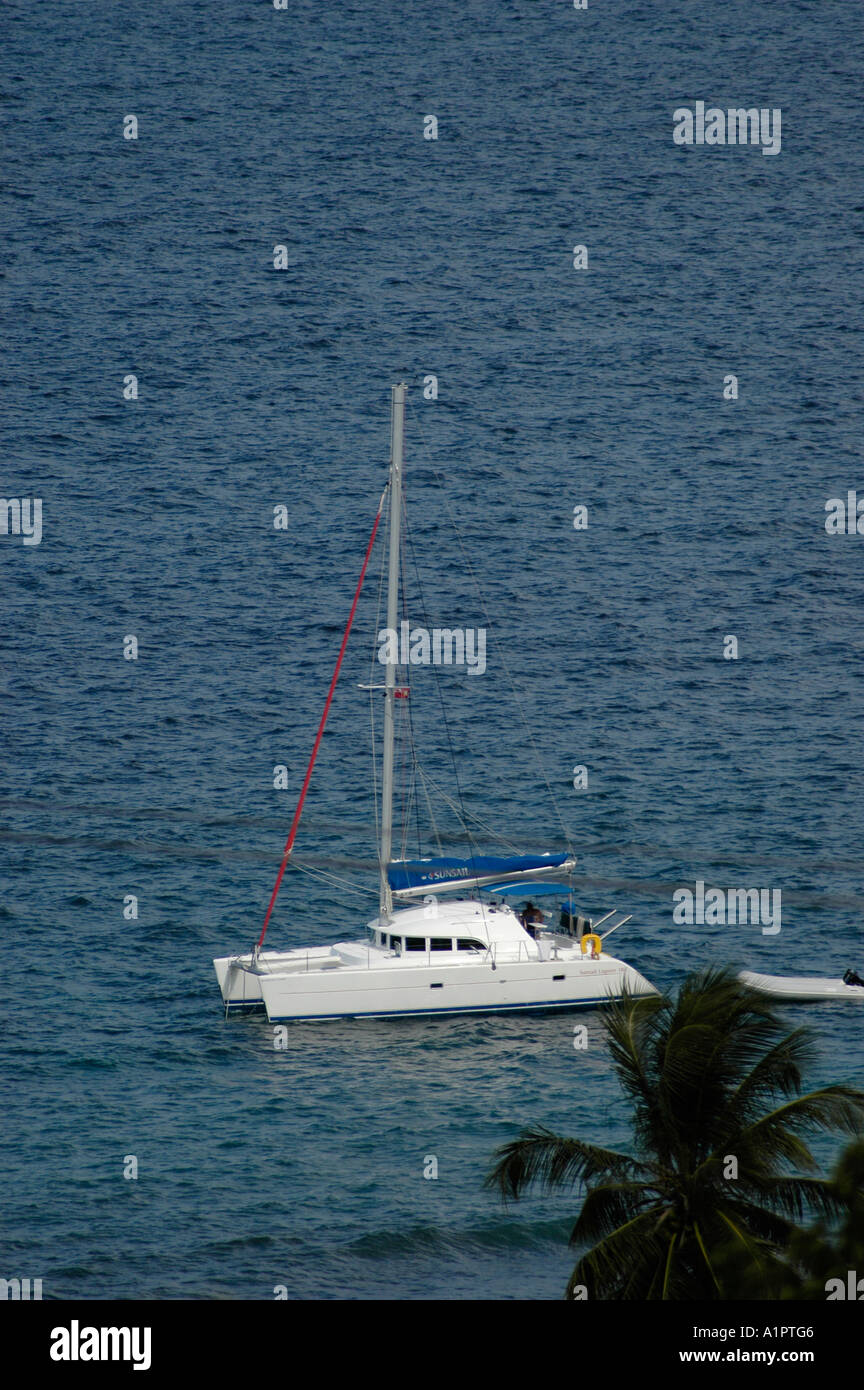 British Virgin Islands Virgin Gorda Sailboat going by shore Stock Photo ...