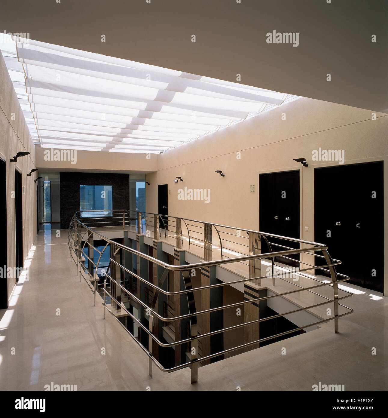 View of railings surrounding an atrium of a building Stock Photo - Alamy