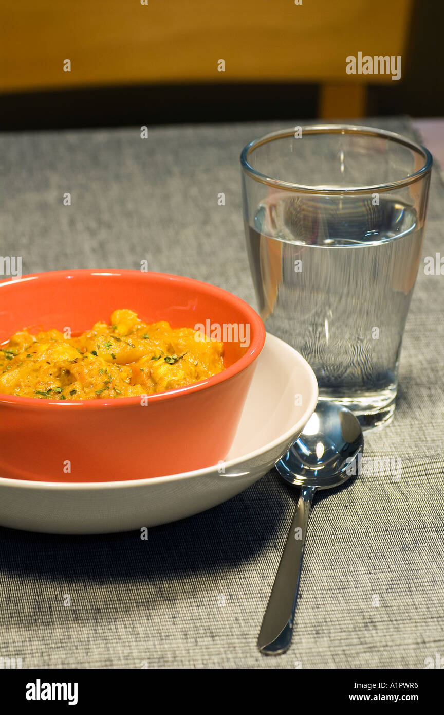 Nyonya Kapitan Curry Chicken and a glass of plain water Stock Photo - Alamy