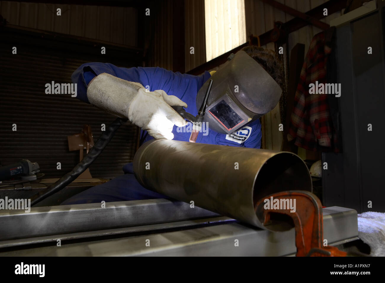 Welder working on a pipe Stock Photo - Alamy