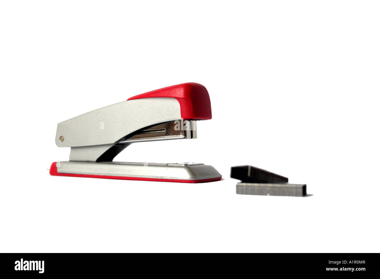 Close-up of a stapler with staples on a white background, showing ...