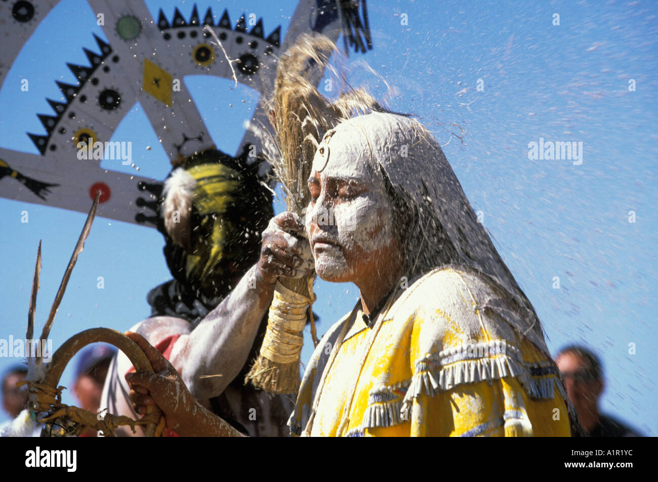 An Apache girl is painted with sacred clay and corn meal during her ...