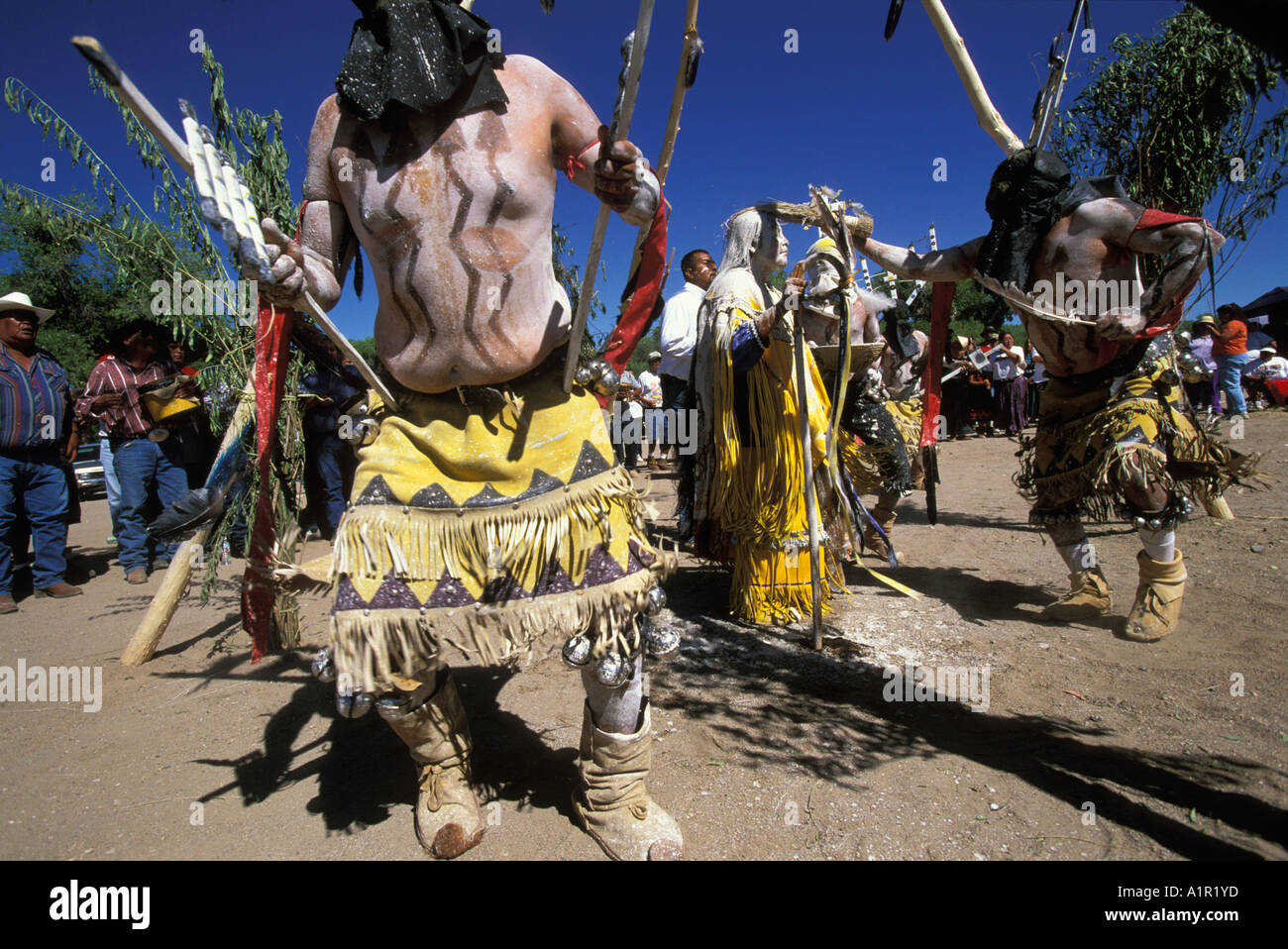 An Apache girl is painted with sacred clay and corn meal during her ...